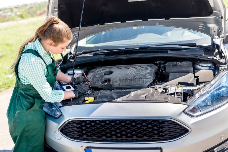 Mechanic - Woman Tests Motor with Tester Stock Photo - Image of ...