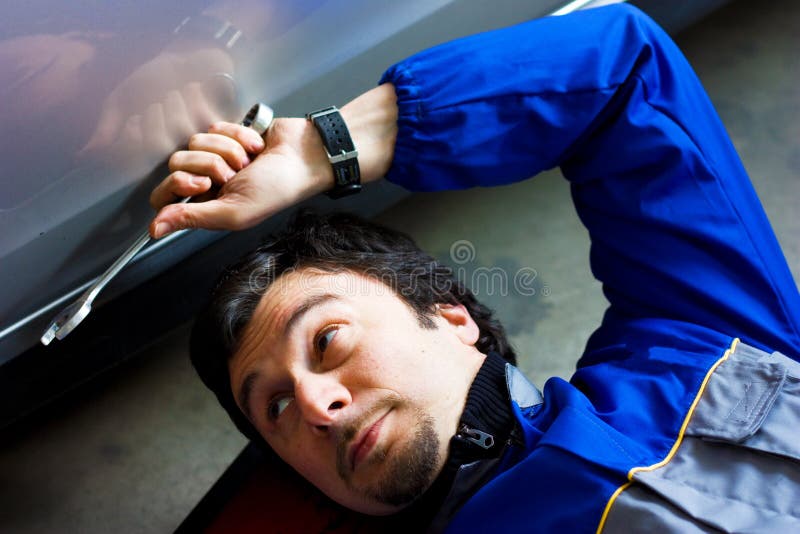 Mechanic at work stock image. Image of collar, lying - 13083365