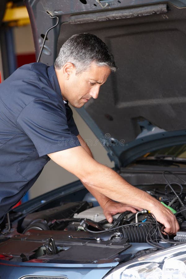 Mechanic at work stock image. Image of bonnet, garage - 21039437