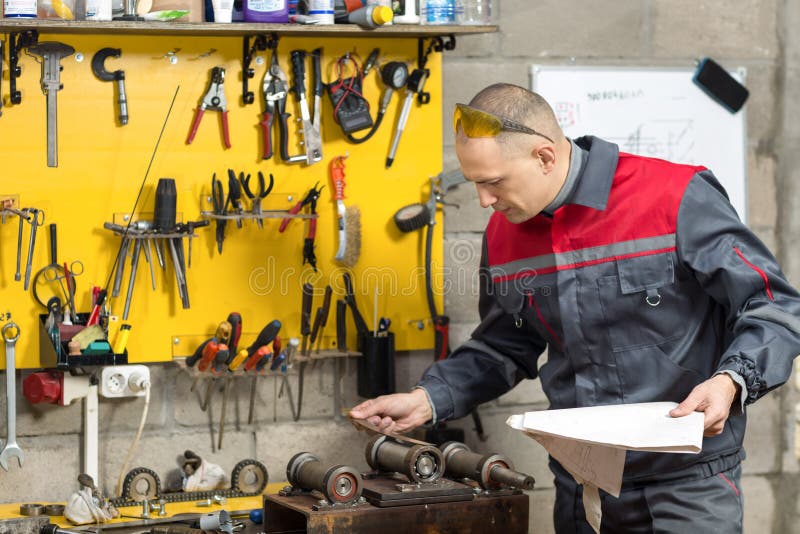 Mechanic Worker Studying His Instructions Stock Image - Image of ...