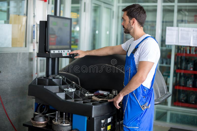 Mechanic Working on Balancing Machine Stock Image - Image of ...