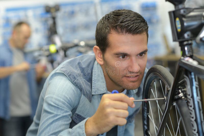 Mechanic Working on Bicycle Wheel Stock Image - Image of tire, biker ...
