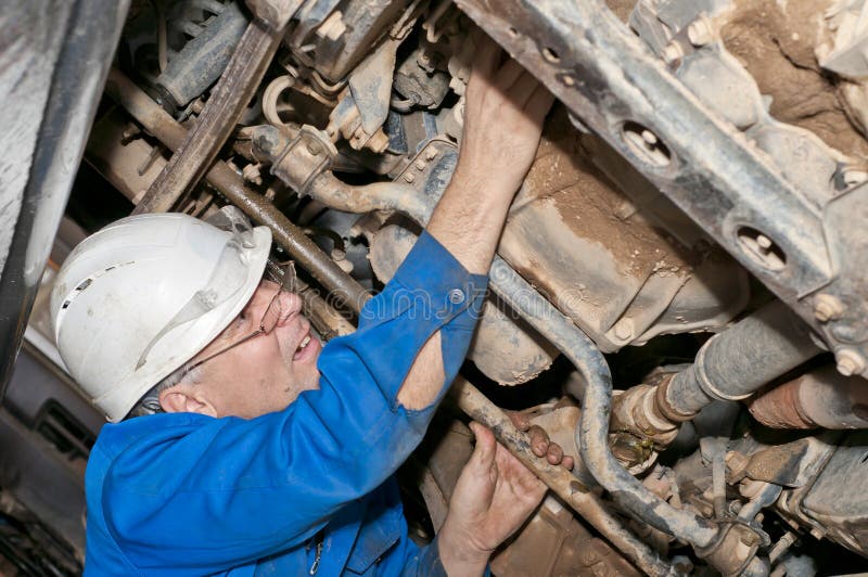 Mechanic Working on a Broken Down Vehicle Stock Photo - Image of poor ...