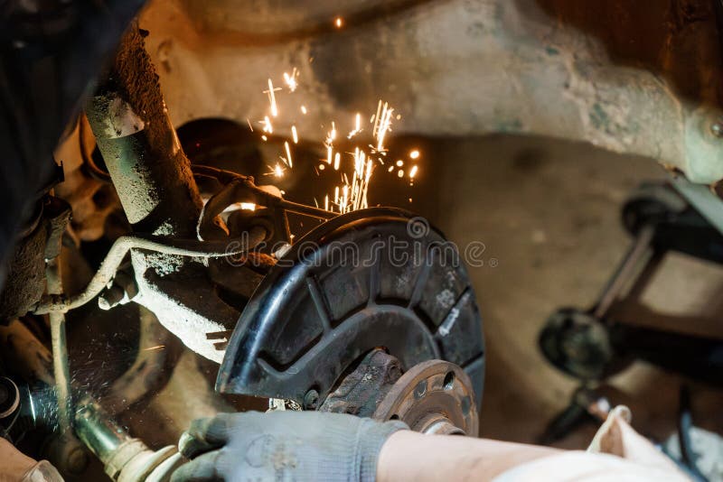 Mechanic Working on Car Brake System with Sparks Flying Stock Image ...