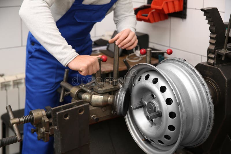 Mechanic Working with Car Disk Lathe Machine at Tire Service Stock ...