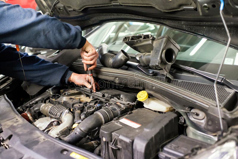 Mechanic Working on a Car Engine Doing Repairs Stock Image - Image of ...