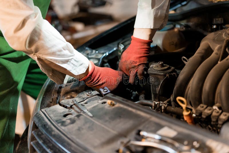 Mechanic Working on Car Engine with Tools in Workshop Stock Image ...