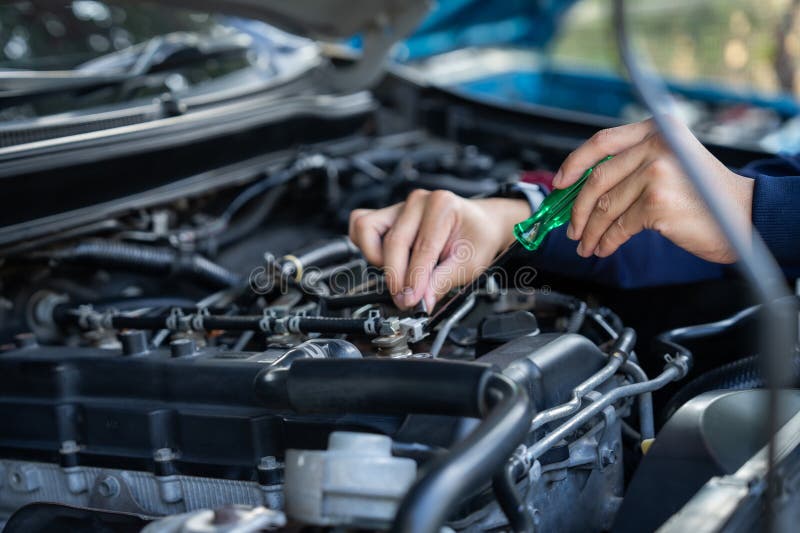 Mechanic is Working on Car Engine Using Green Tools. Focused and ...