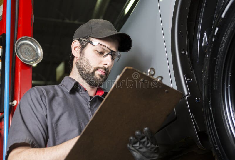 Mechanic Working on Car in His Shop Stock Image - Image of person ...