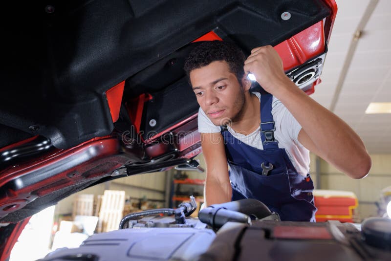 Mechanic working on car stock image. Image of industry - 259239951