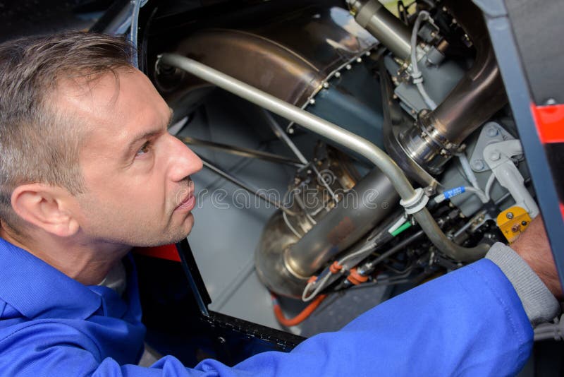 Mechanic working on engine stock photo. Image of profile - 206331872