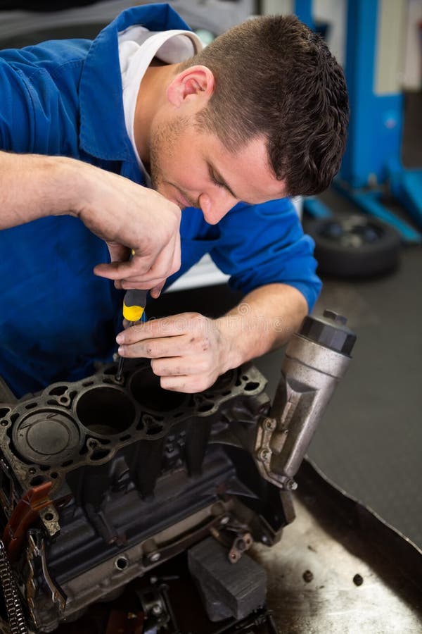 Mechanic Working on an Engine Stock Image - Image of vehicle, indoors ...