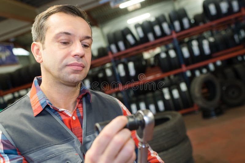 Mechanic working at garage stock image. Image of toolbox - 260782145