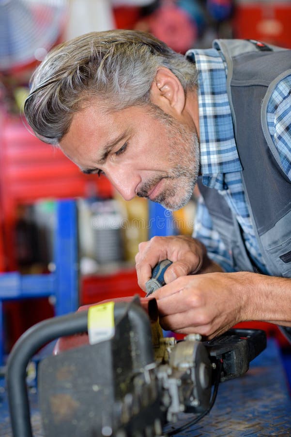 Mechanic Working on Hedge Trimmer Stock Photo - Image of machine ...