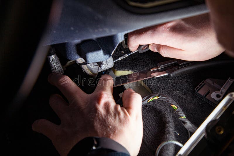 A Mechanic Working on the Interior of a Car Using Different Panel ...