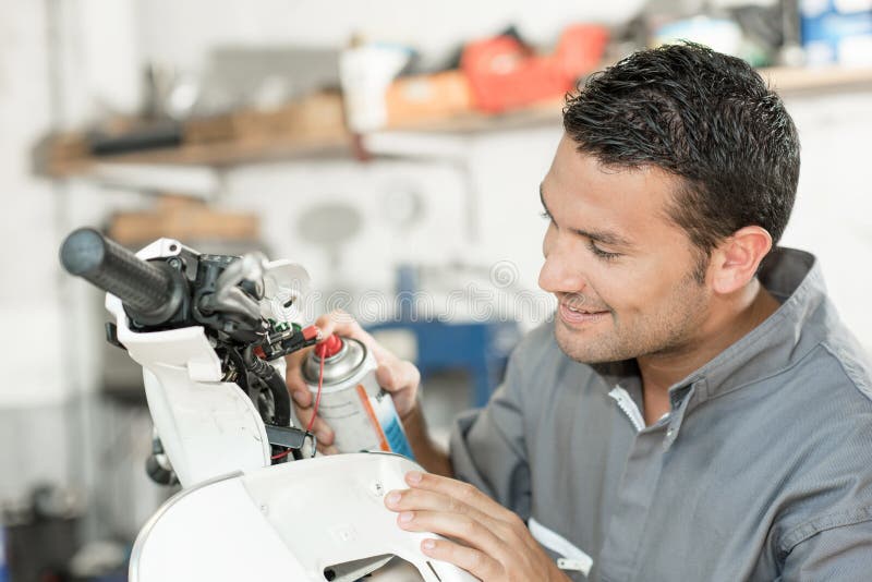 Mechanic Working on Scooter Stock Image - Image of overalls ...