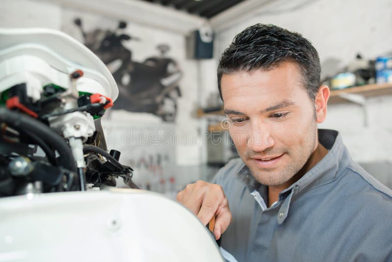 Mechanic Working on Scooter Stock Photo - Image of issue, automobile ...