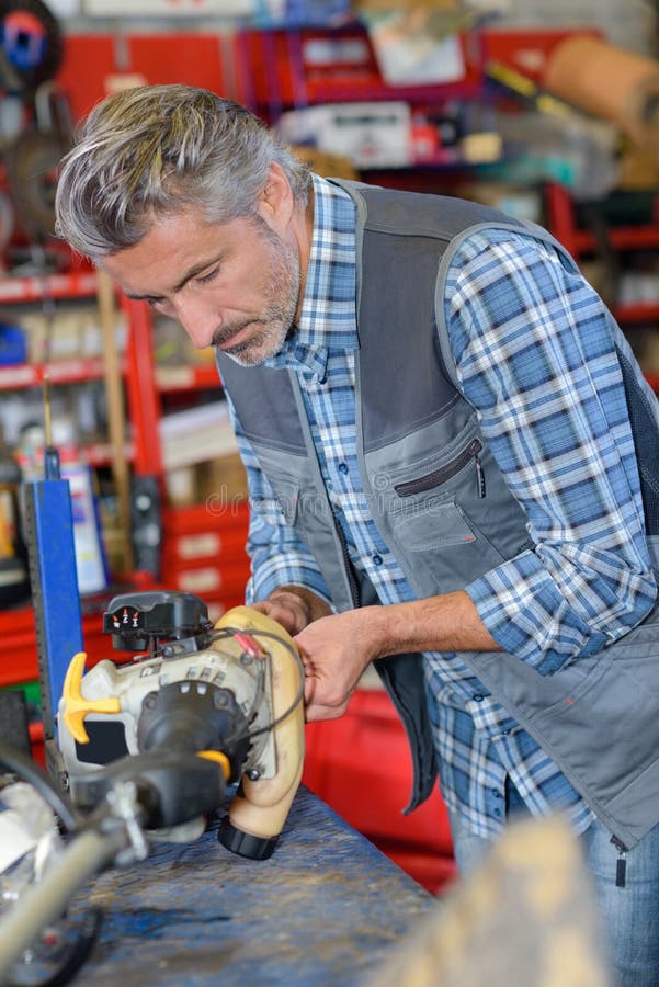 Mechanic Working on Trimmer Stock Photo - Image of work, equipment ...
