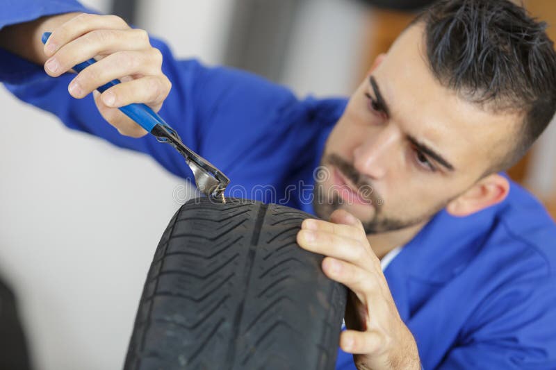 Mechanic Working on Tyre at Workshop Stock Photo - Image of repairman ...