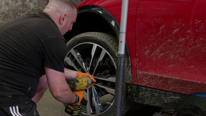 Mechanic working on wheels stock image. Image of hand - 23814447