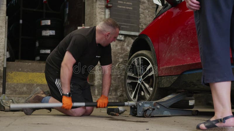 Mechanic Working on Vehicles, Changing Tires, Aligning Wheels, and ...