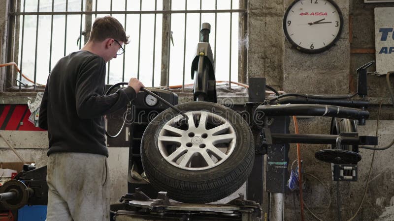 Mechanic Working on Vehicles, Changing Tires, Aligning Wheels, and ...