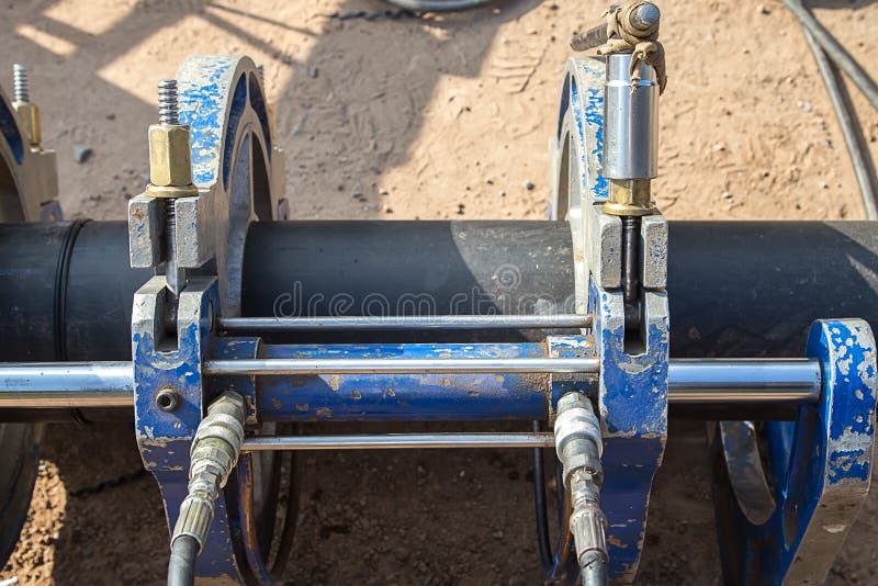 The Mechanic Works at a Welding Machine for Connection of Plastic Pipes ...