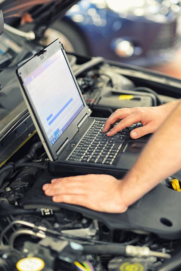 Mechanic in a Workshop Checks and Checks the Electronics of the Car ...