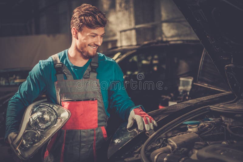Mechanic in a workshop stock image. Image of automobile - 60704495