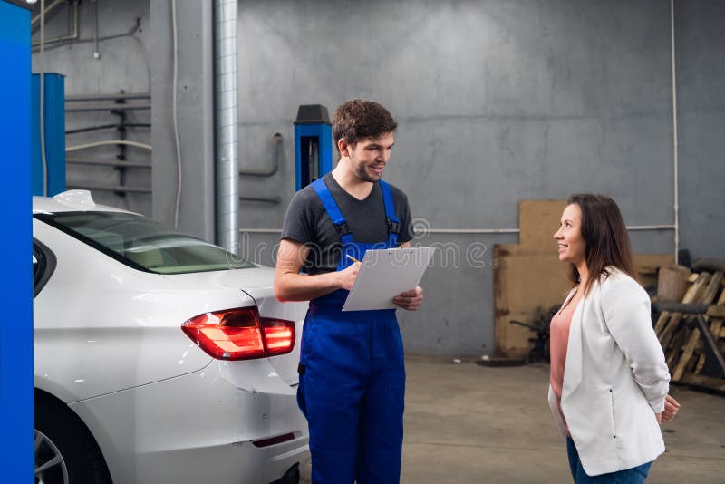Workshop Worker with Clipboard in Hands Speaks with Client Stock Image ...