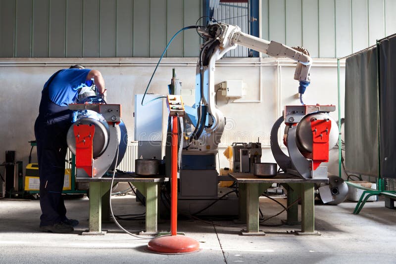 Man and Robotic Machine Work Together Inside Industrial Building. Stock ...