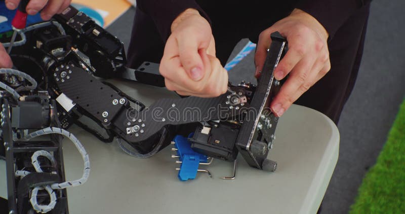 Mechanical Assembly of the Robot Using a Screwdriver. Hands of a ...