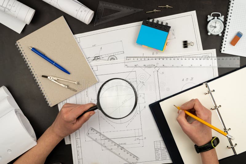Mechanical Drawing on Sheets of Paper. Hands on the Table Top View ...