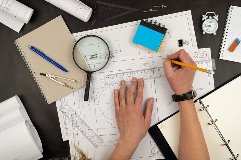 Mechanical Drawing on Sheets of Paper. Hands on the Table Top View ...