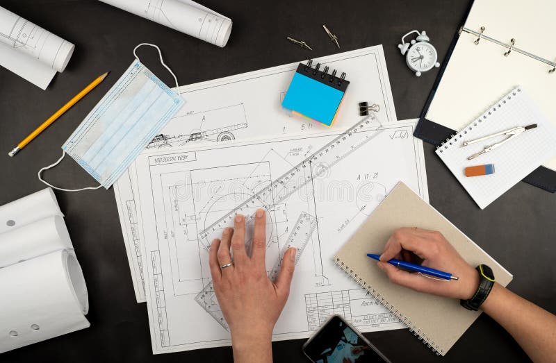 Mechanical Drawing on Sheets of Paper. Hands on the Table Top View ...