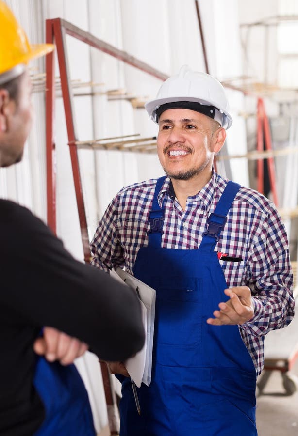 Mechanical Engineer Inspecting the Work of Labour at Factory Stock ...