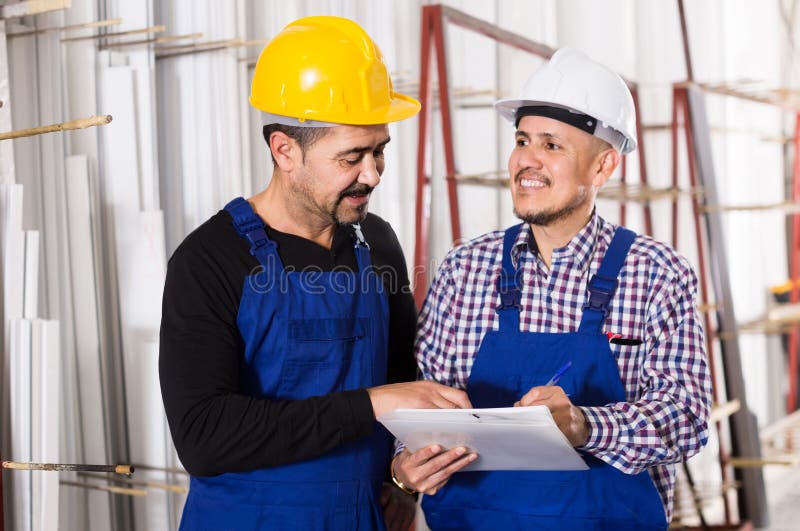 Mechanical Engineer Inspecting the Work of Labour at Factory Stock ...
