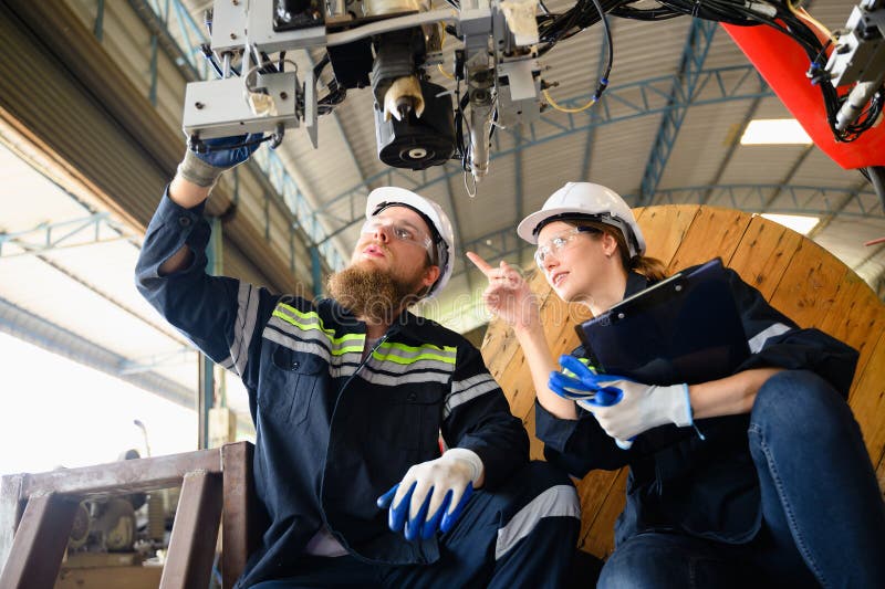 Mechanical Engineers Repairing Engine Machine at Factory Stock Photo ...