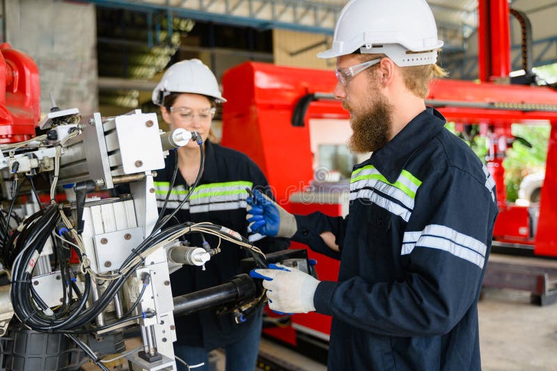 Mechanical Engineers Repairing Engine Machine at Factory Stock Image ...