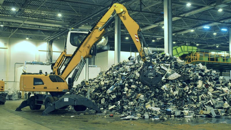 Mechanical Loader is Grabbing Garbage and Putting it into a Pile ...