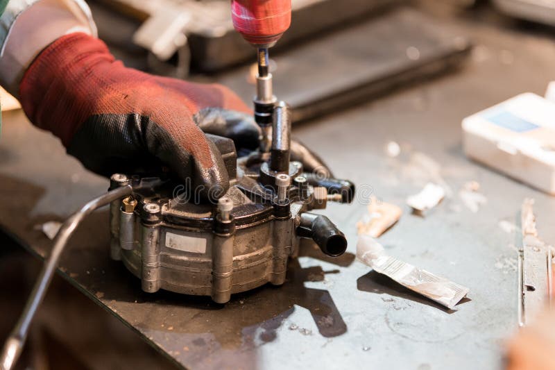 Mechanical Technician Assembling a Fuel Pump Component in a Workshop ...