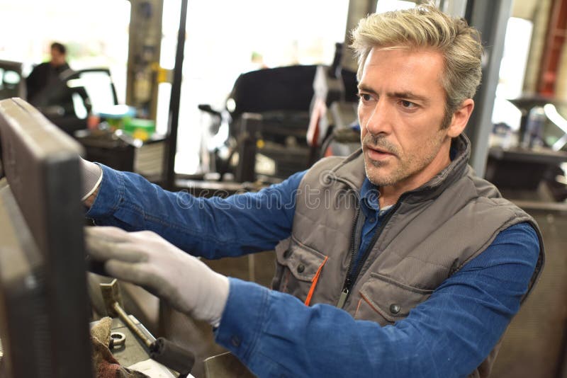 Mechanical Worker Setting Up Machines in Car Workshop Stock Photo ...