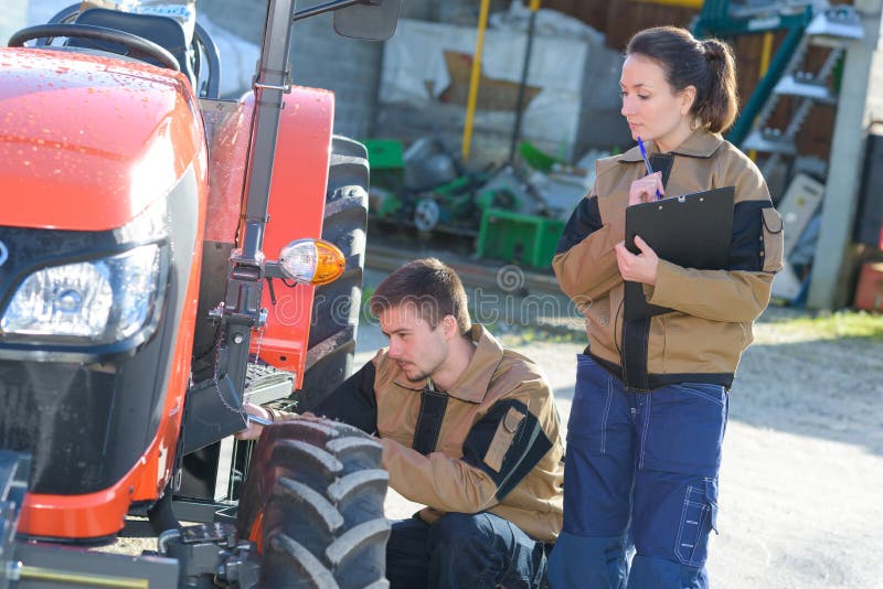 Mechanicians Examining Tractors Engine Stock Photo - Image of ...
