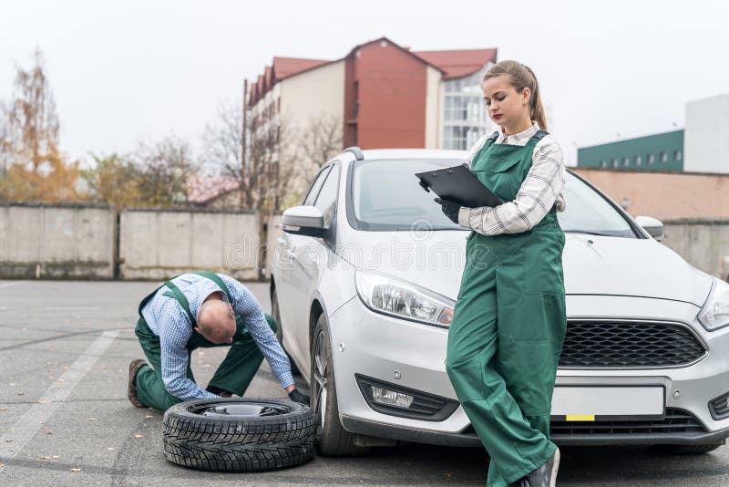 Mechanics Changing Wheel of a Car at Service Stock Photo - Image of ...