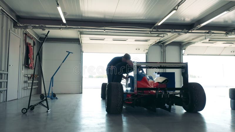 Mechanics are Checking the Cabin of a Racing Car Stock Footage - Video ...
