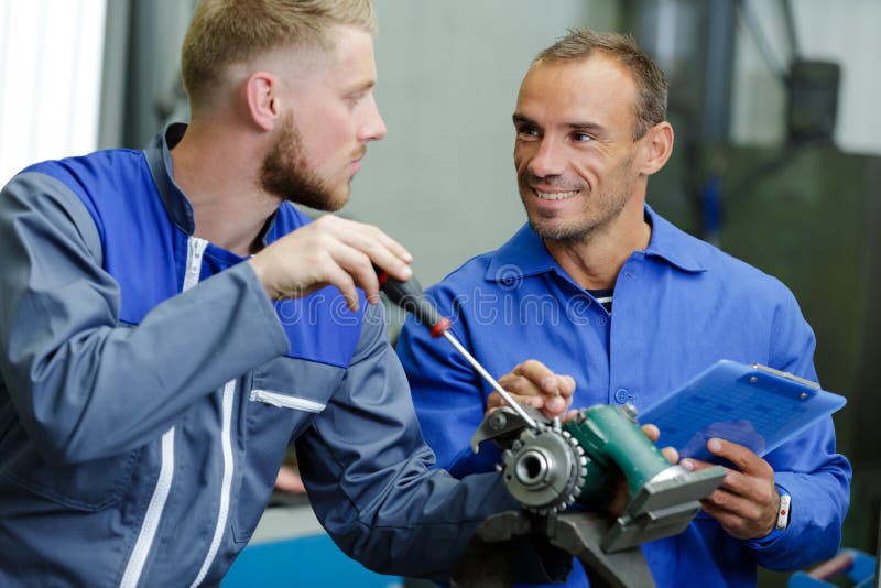 Mechanics Fixing Pice on Machine Stock Photo - Image of company ...