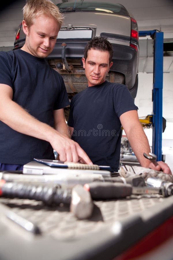 Mechanics Looking at Work Order Stock Image - Image of portrait, honest ...