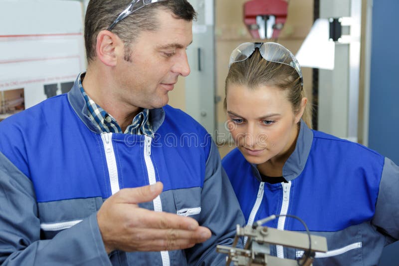 2mechanics Man and Woman Fixing Something Stock Image - Image of work ...