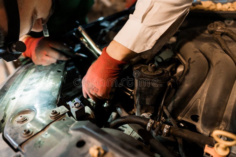 Mechanics Performing Car Engine Repair at Night Stock Photo - Image of ...