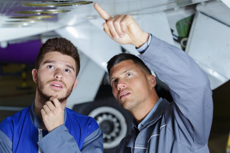 Mechanics in Pit Looking Up at Car Stock Image - Image of auto, tuning ...